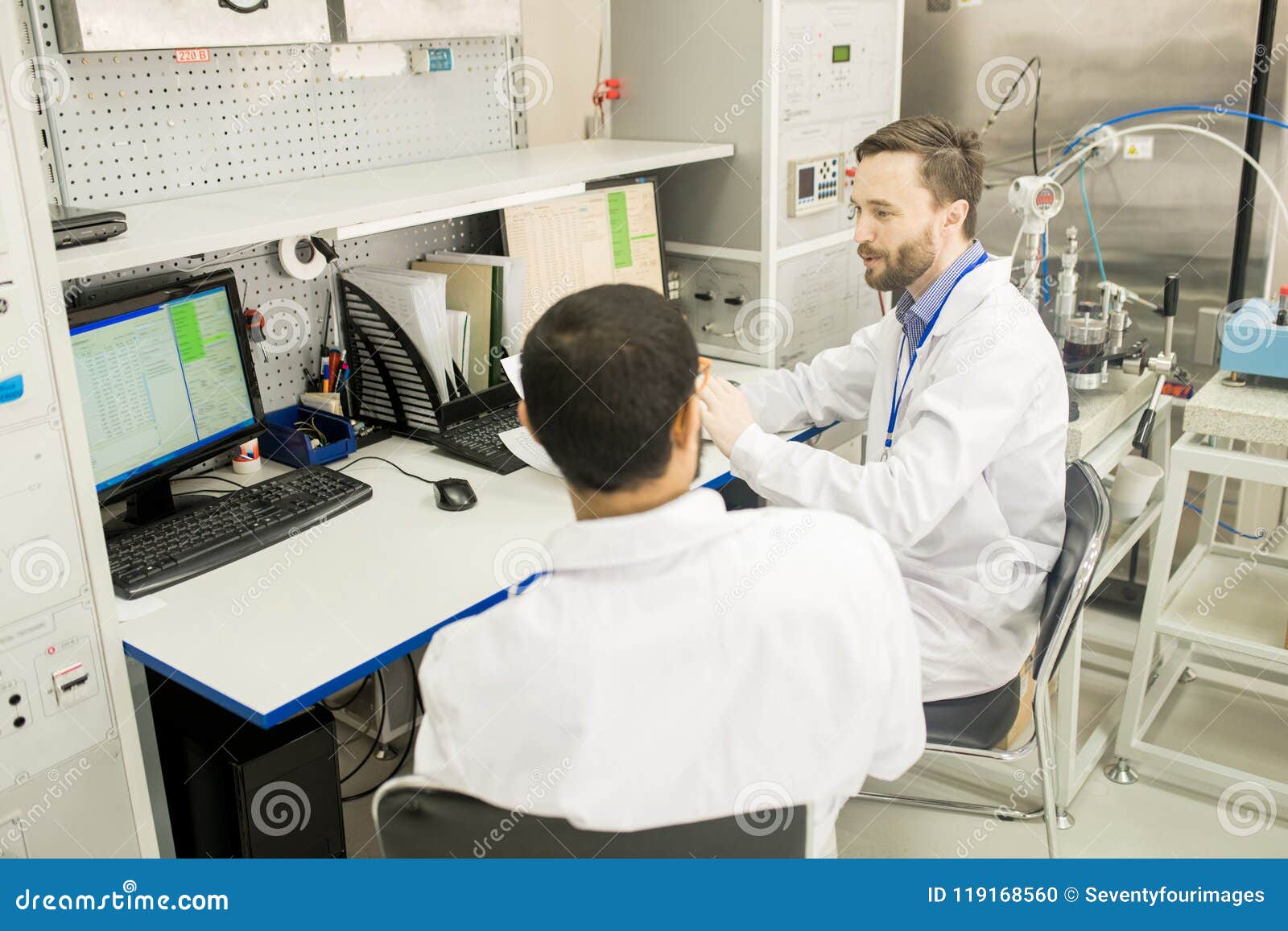 Lab Technicians Wrapped Up in Work Stock Photo - Image of device ...