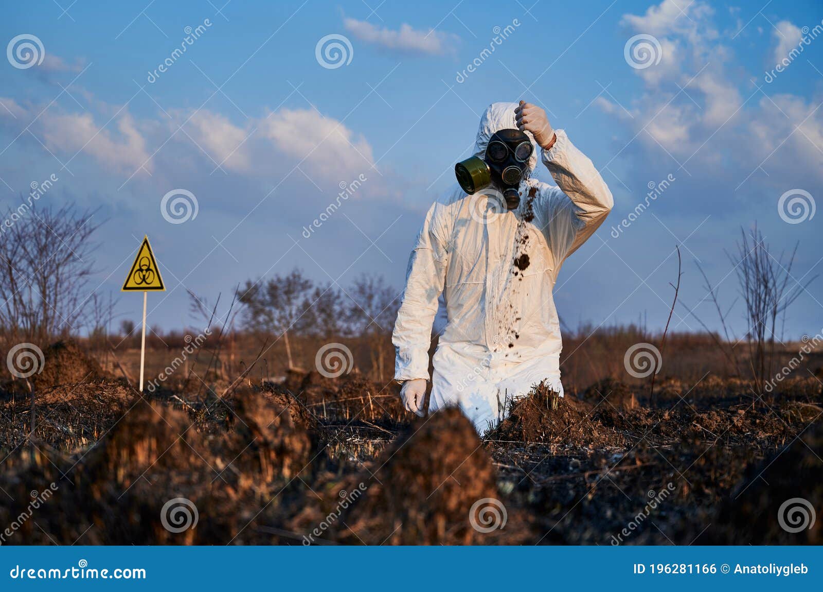 Lab Worker in a Protective Costume Working in Scorched Field Stock ...