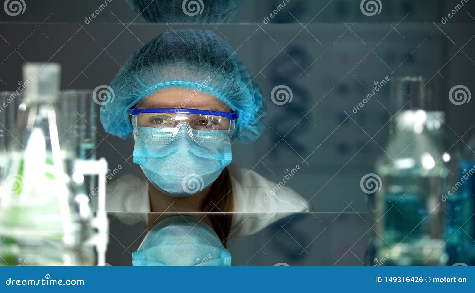 Lab Worker in Protective Eyeglasses and Uniform Looking at Chemical ...