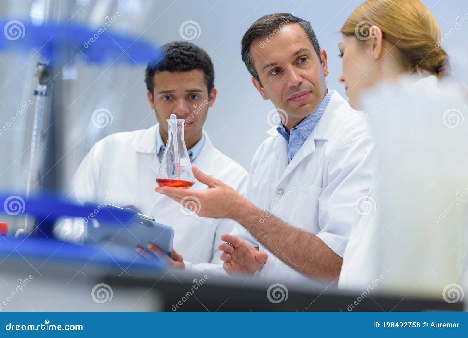 Lab worker with students stock photo. Image of glassware - 198492758