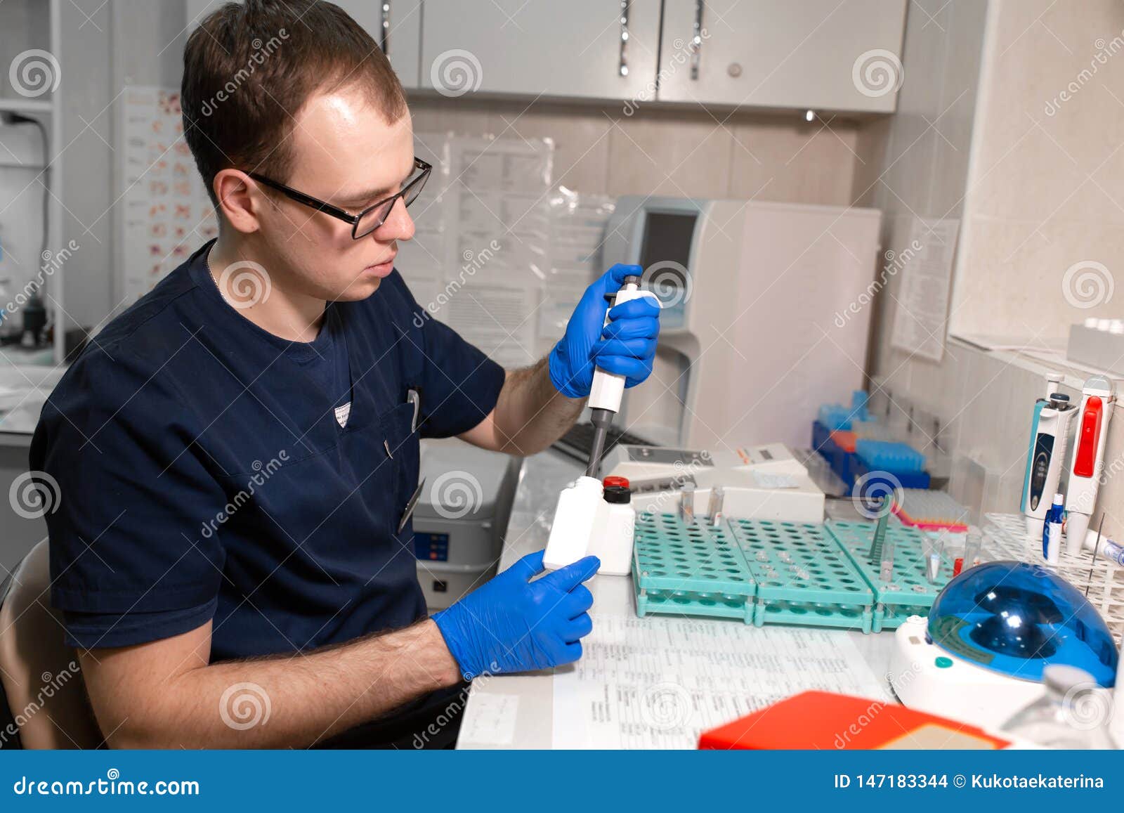 Laboratory Assistant Analyzing a Blood Sample Using Micropipette Stock ...