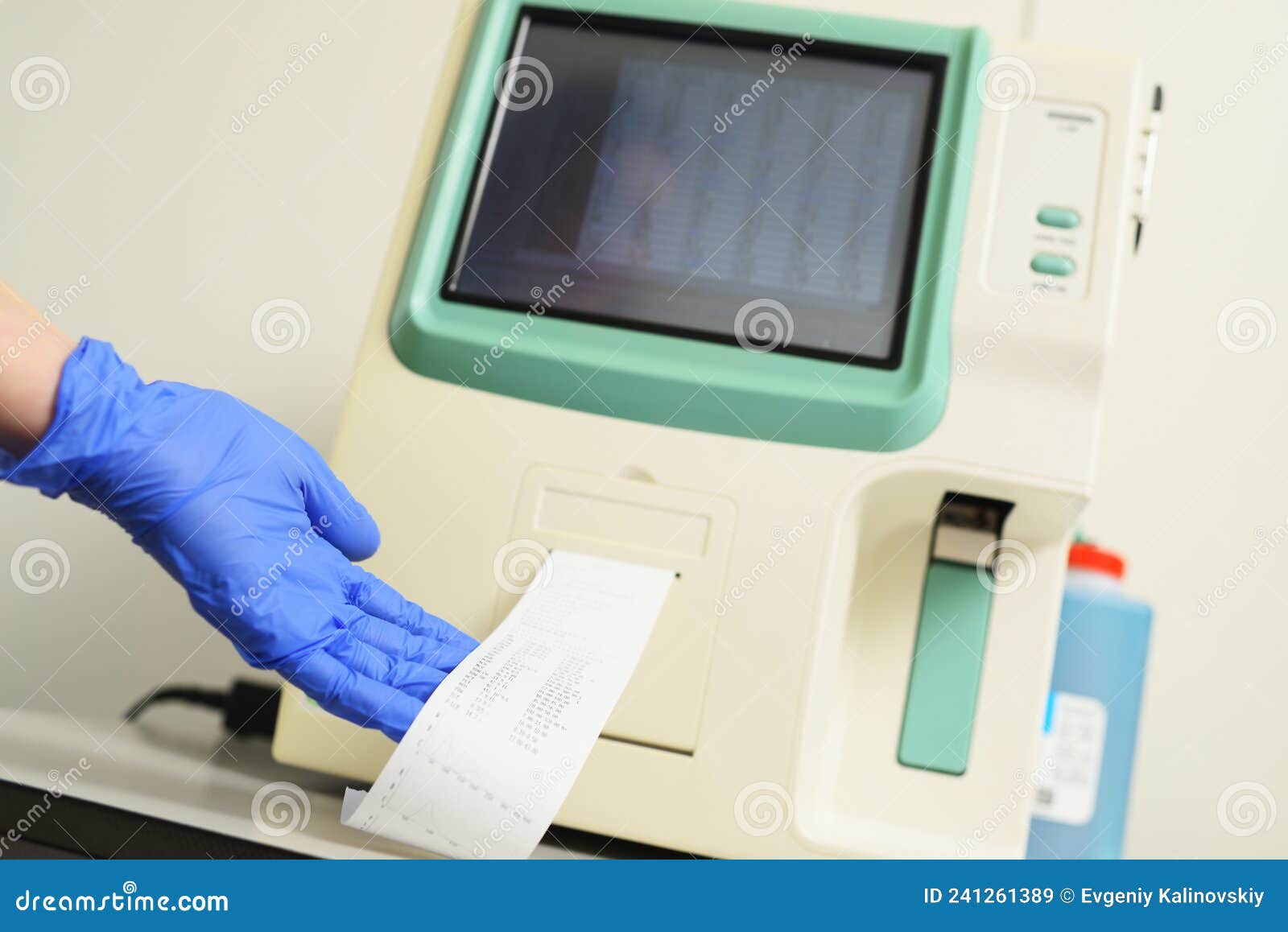A Laboratory Assistant Examines a Blood Sample in an Analyzer in a ...