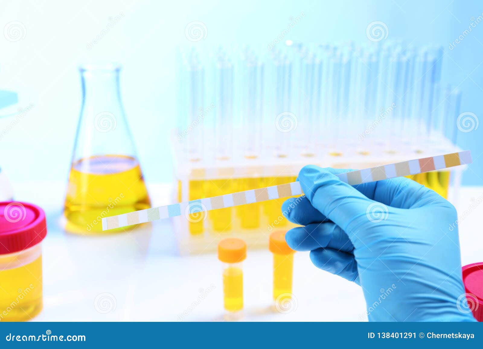 Laboratory Assistant Holding Litmus Paper for Analysis Over Table Stock ...