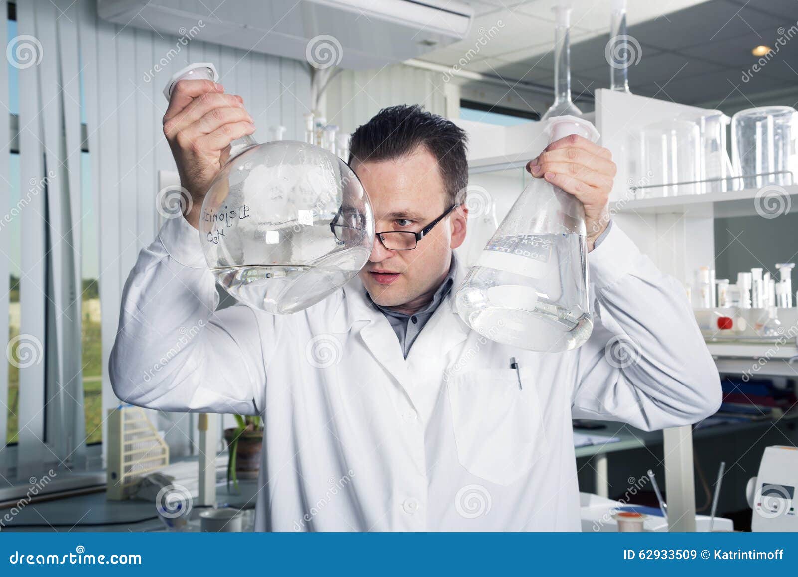 Laboratory Assistant Looking in a Bottle with Liquid Stock Image ...