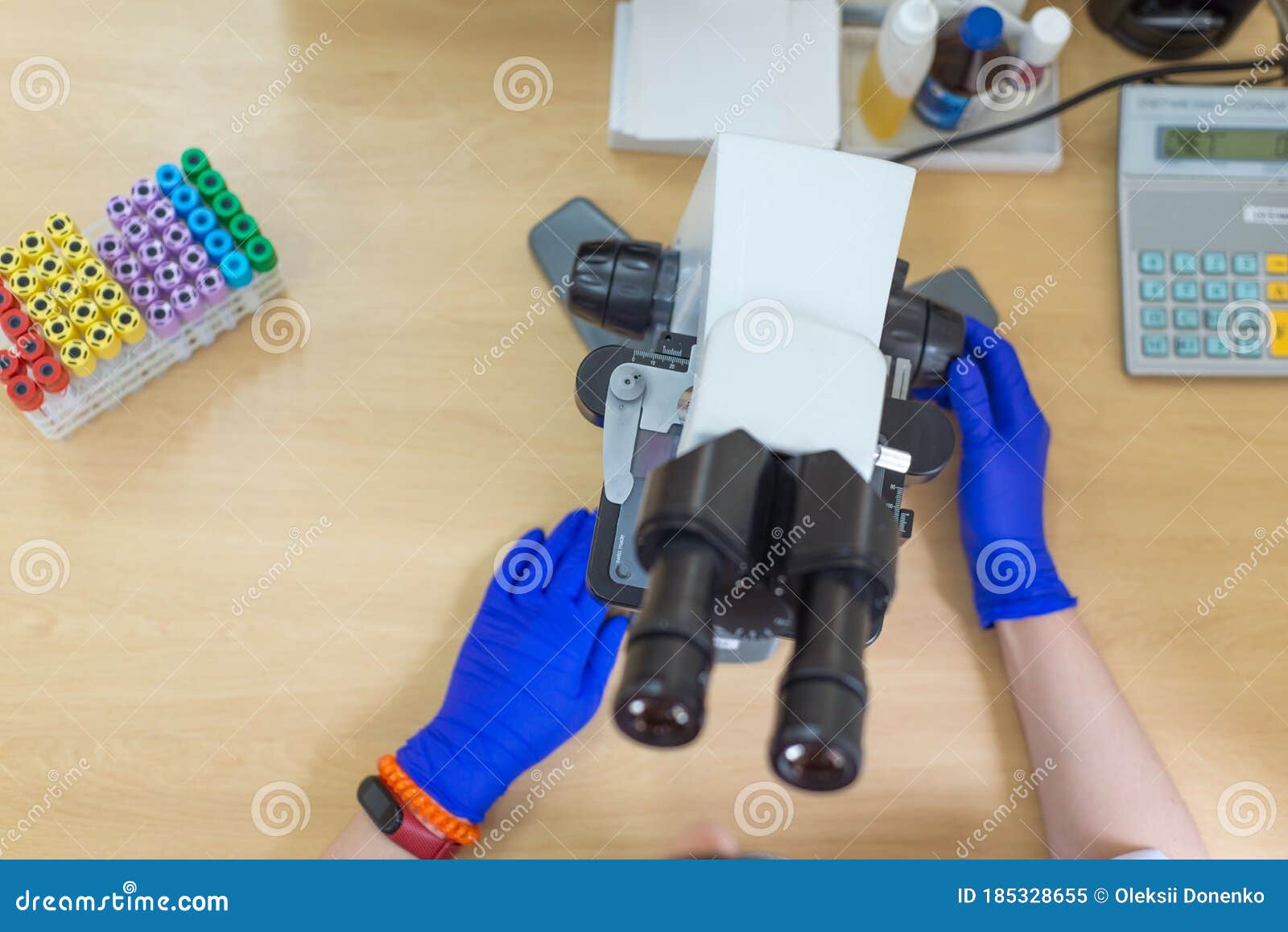 Laboratory Assistant is Looking through a Microscope. Close-up Doctor ...