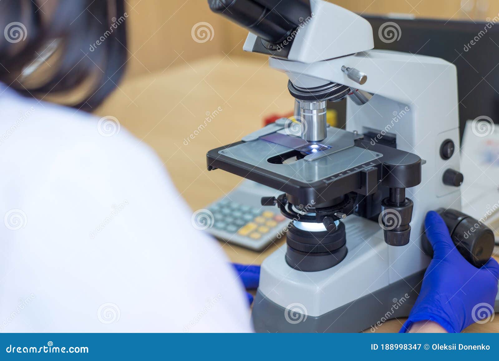 Laboratory Assistant is Looking through a Microscope. Close-up Doctor ...