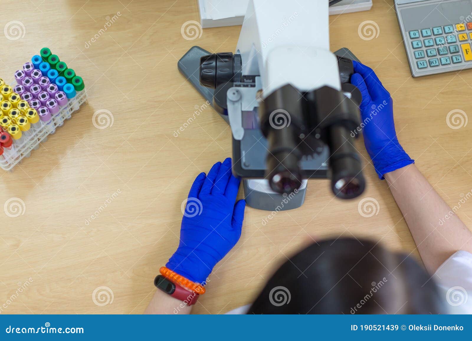 Laboratory Assistant is Looking through a Microscope. Close-up Doctor ...