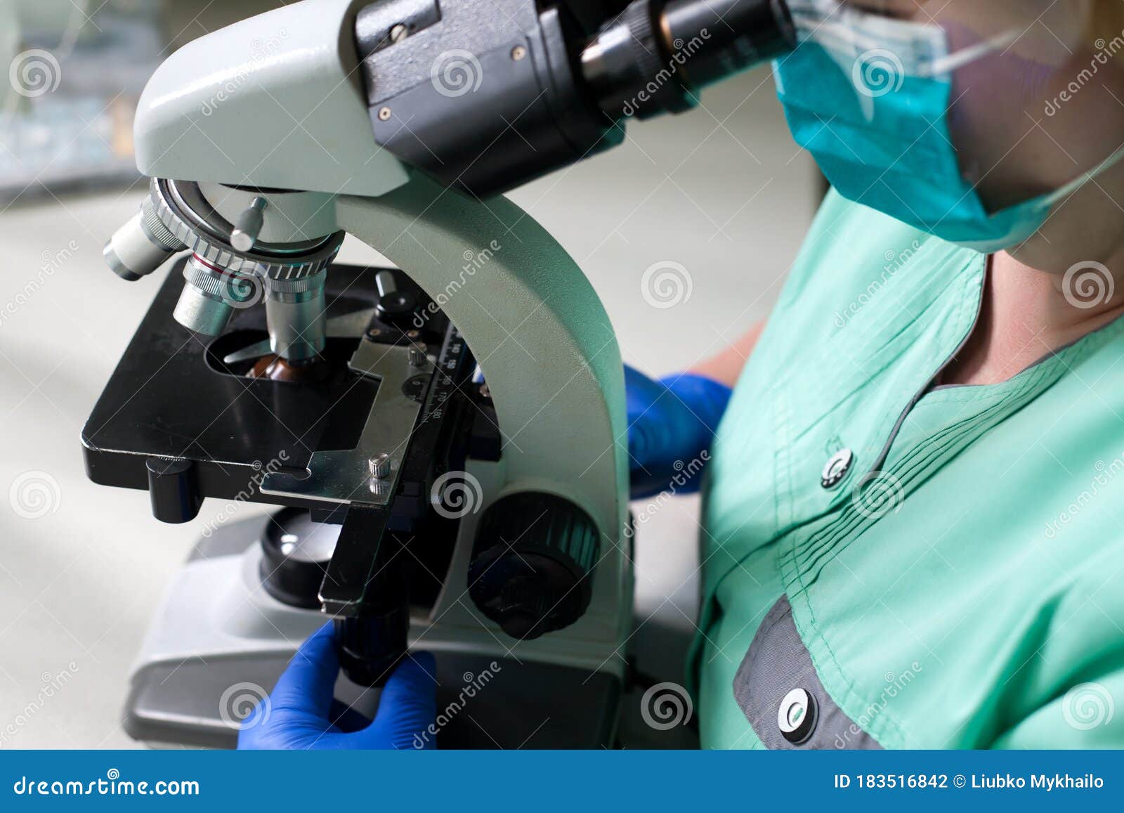 The Laboratory Assistant is Looking through a Microscope. Laboratory ...