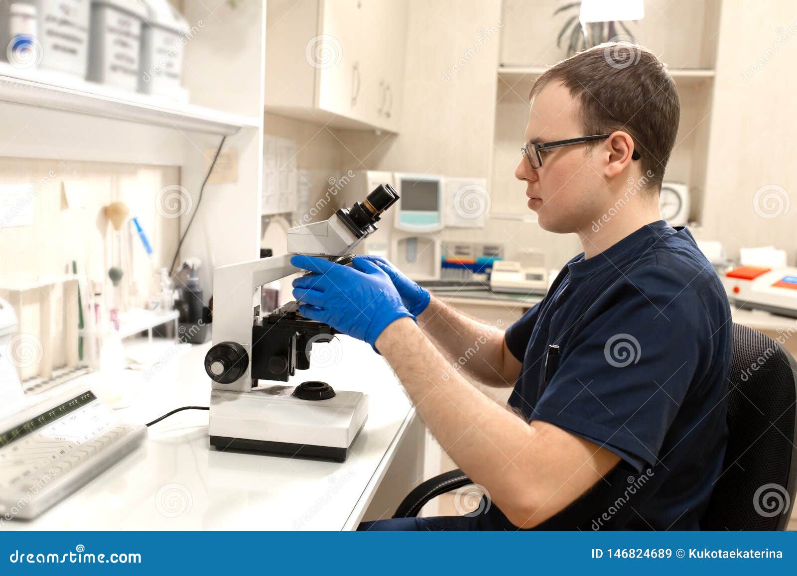 Laboratory Assistant Looking through Microscope. Make Research in ...