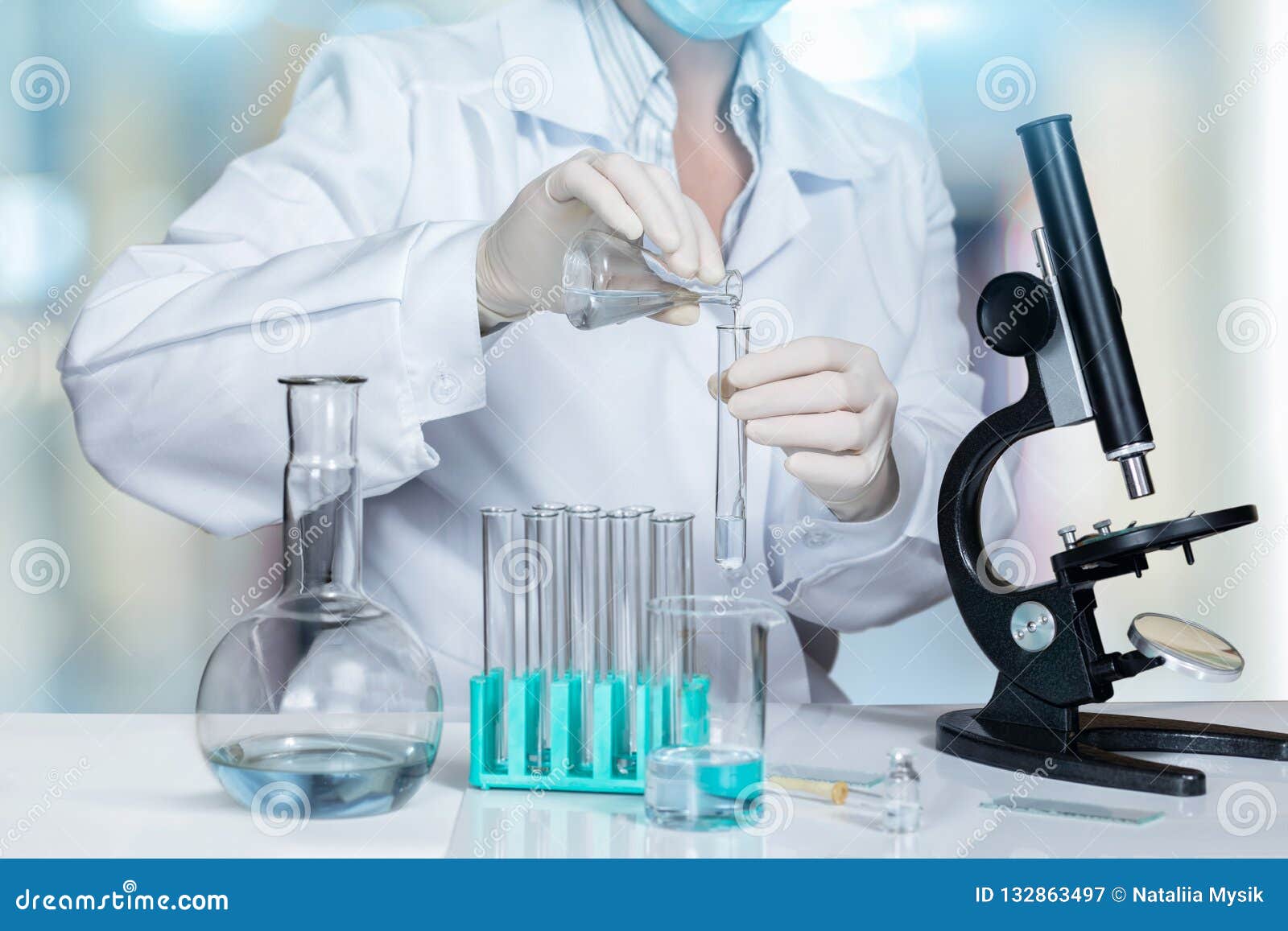 A Laboratory Assistant is Making Some Experiments with a Microscope and ...