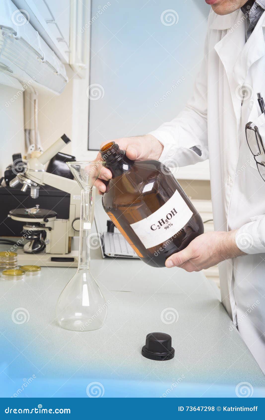 Laboratory Assistant Pours from a Bottle with Written Formula of ...