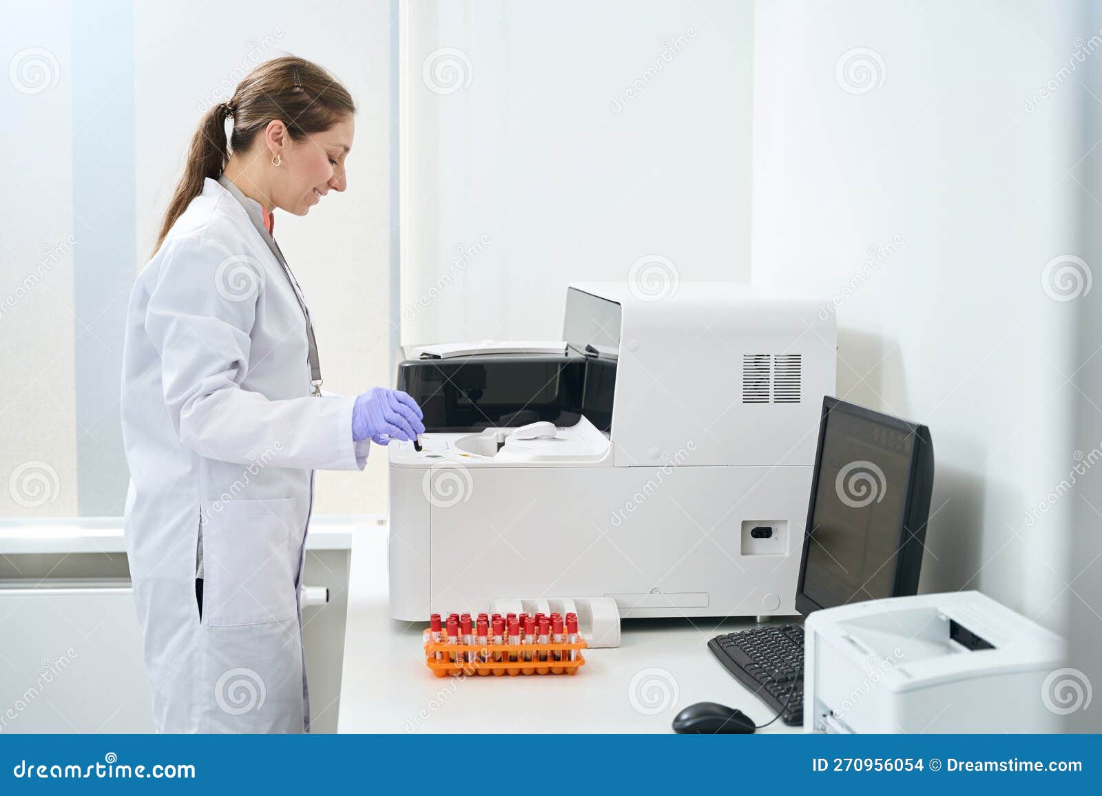 Laboratory Assistant Stands Near a Hematological Analyzer in Testing ...