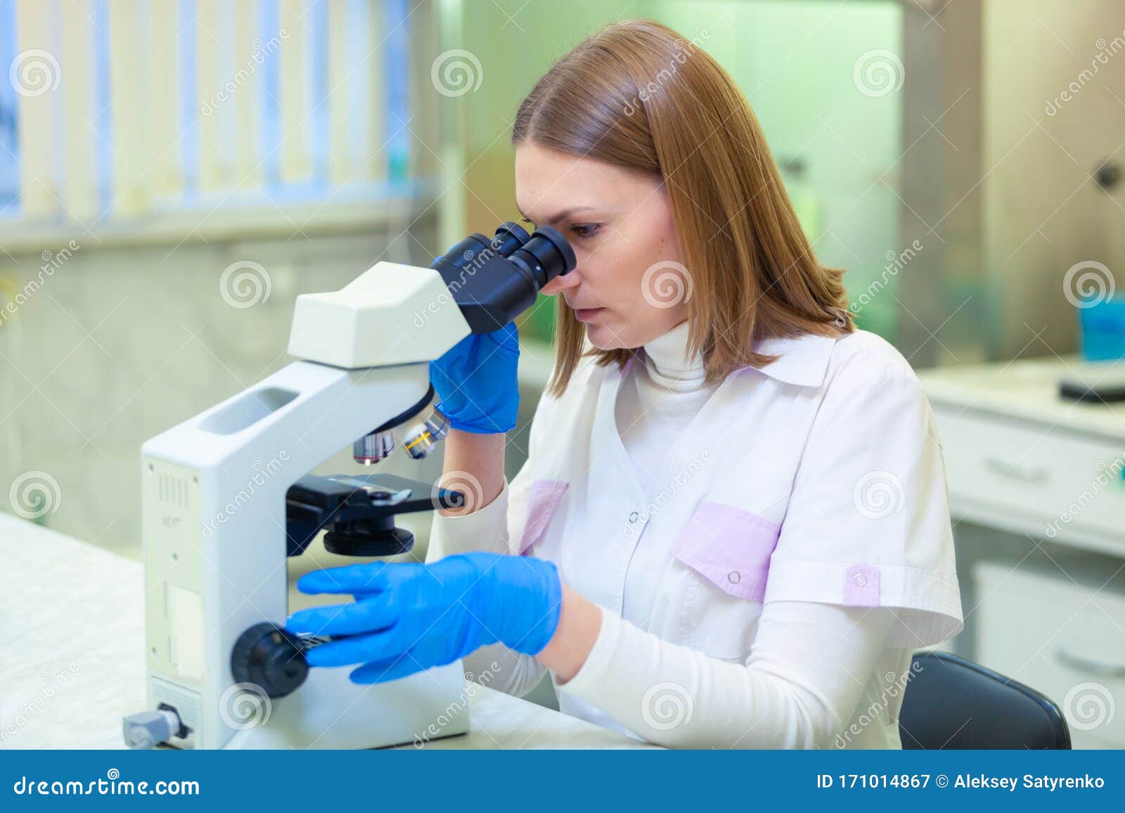 Laboratory Assistant Working with a Microscope in a Scientific ...