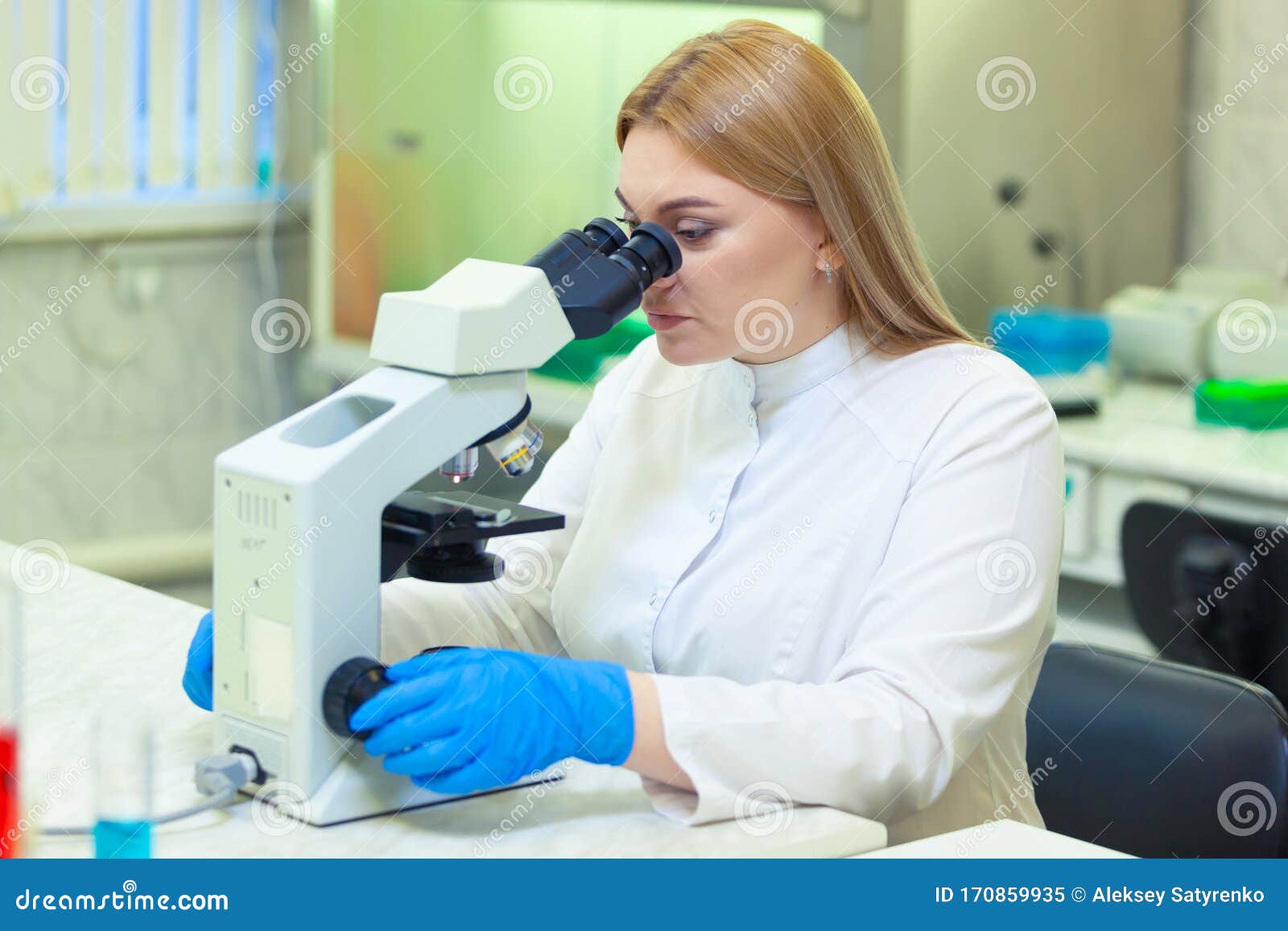 Laboratory Assistant Working with a Microscope in a Scientific ...