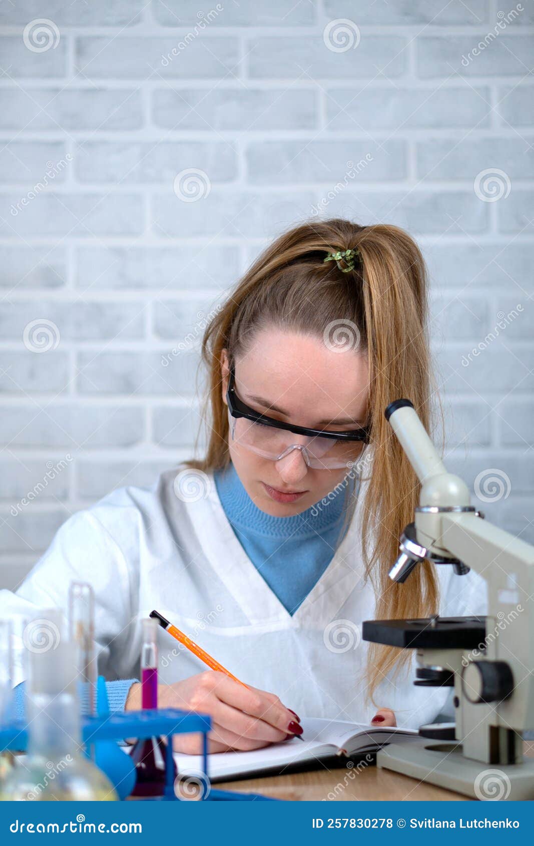 The Laboratory Assistant Writes Down the Results of the Experiments in ...