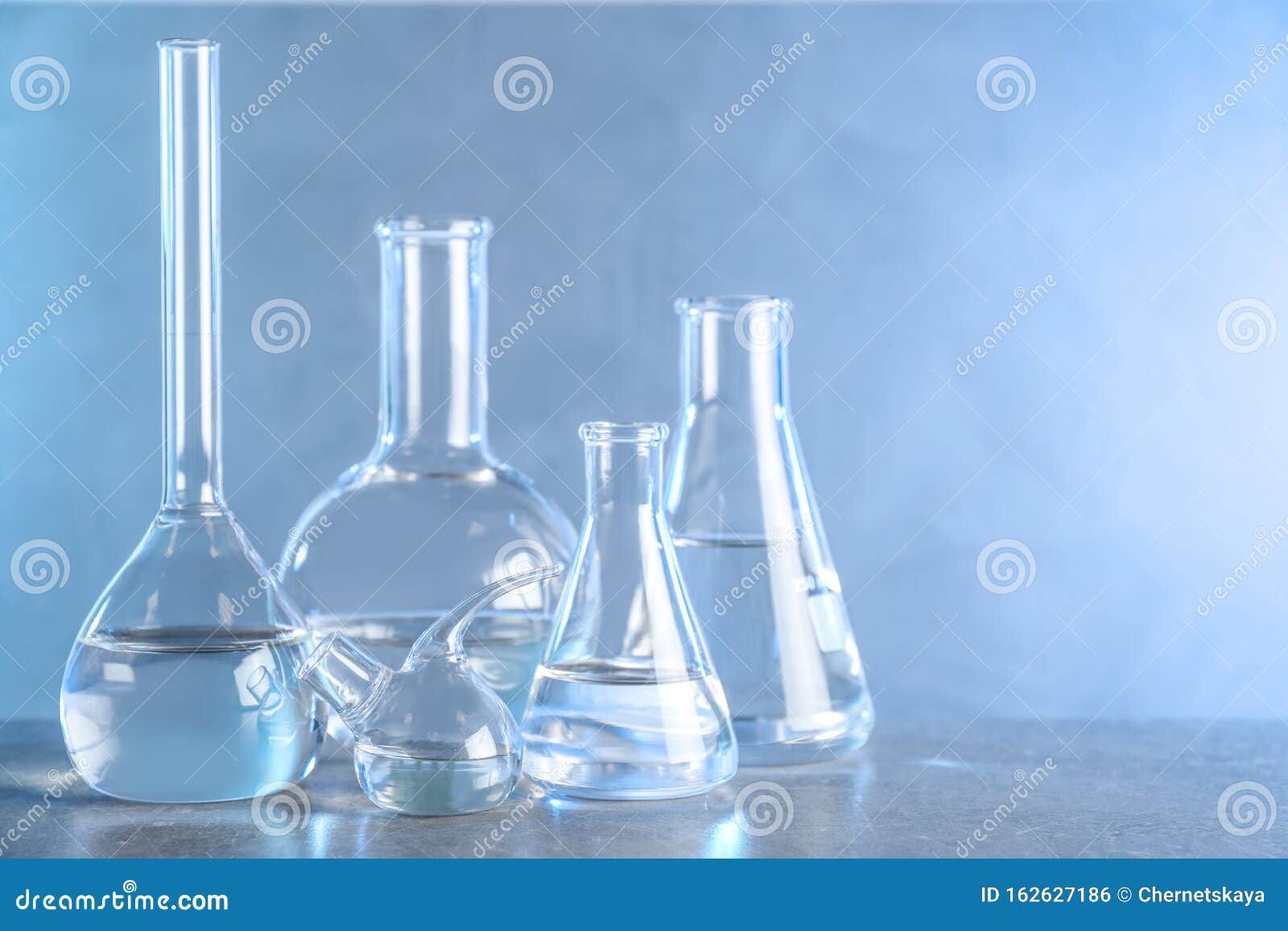 Laboratory Glassware with Liquid Samples for Analysis on Table Against ...