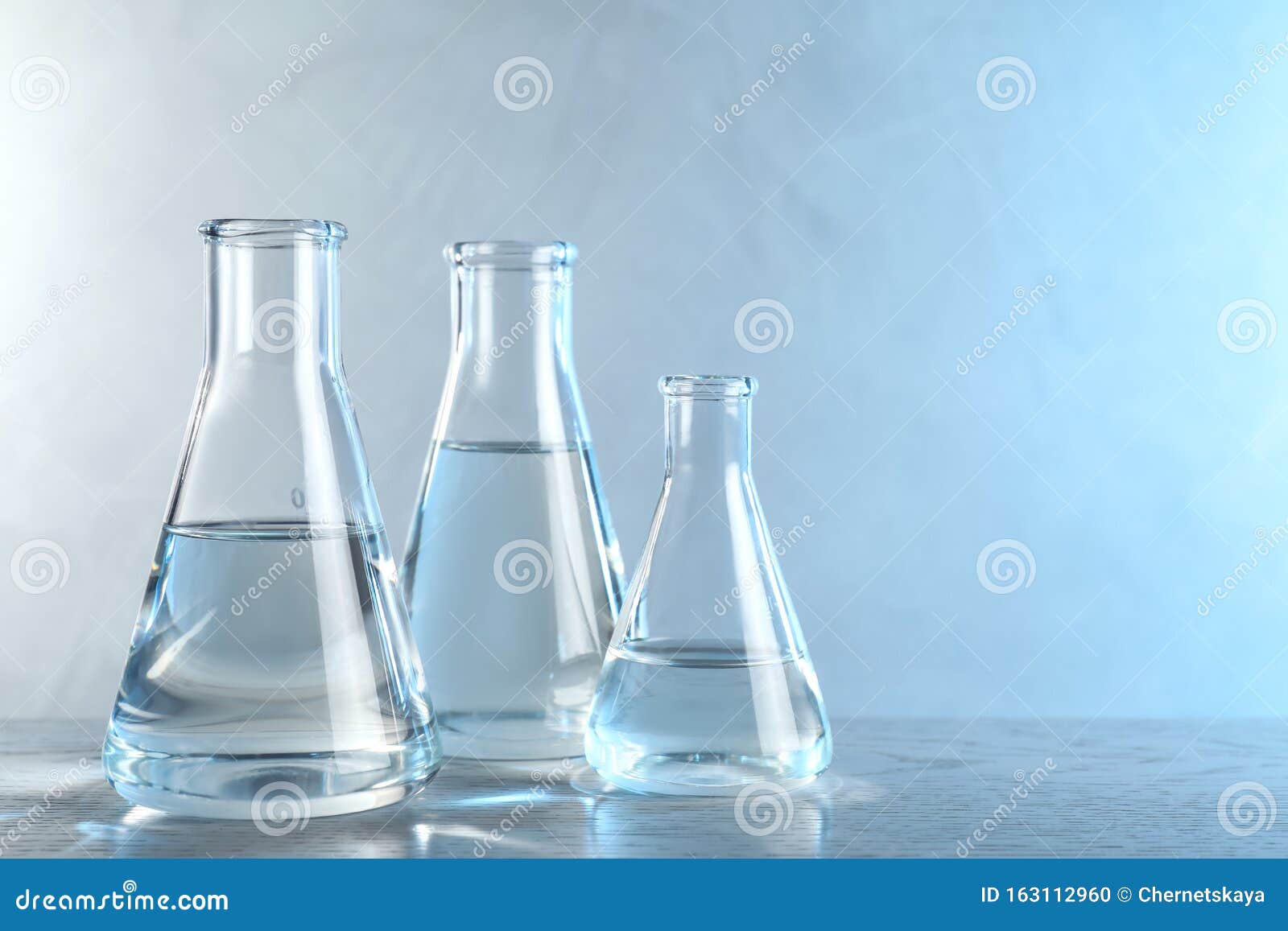 Laboratory Glassware with Liquid Samples for Analysis on Table Against ...