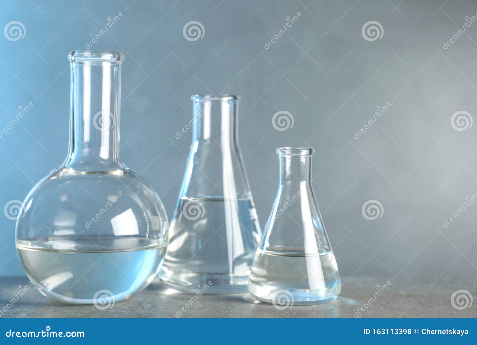 Laboratory Glassware with Liquid Samples for Analysis on Table Against ...