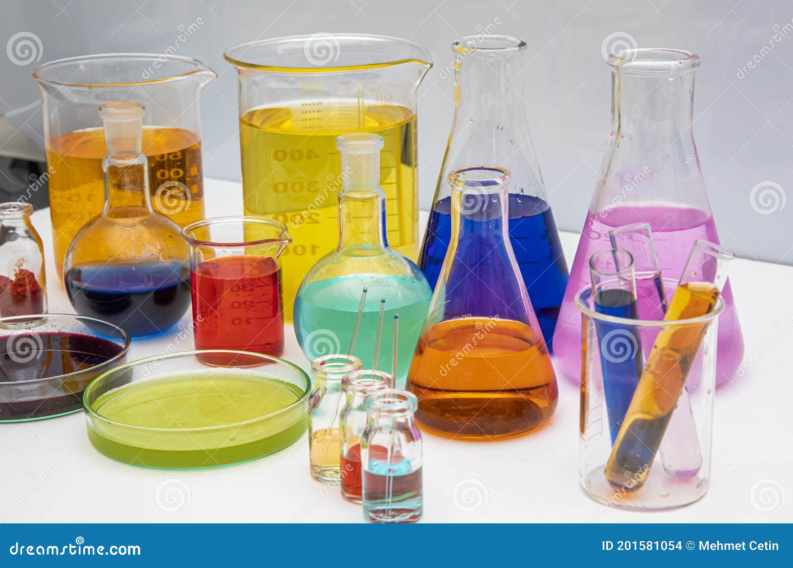 Laboratory Glassware with Liquids of Different Colors on White Table ...