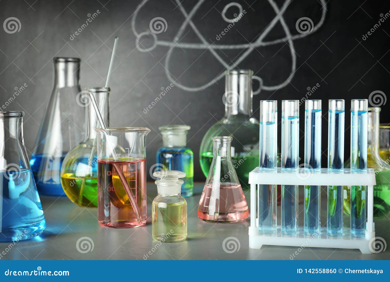 Laboratory Glassware on Table Near Chalkboard Stock Photo - Image of ...