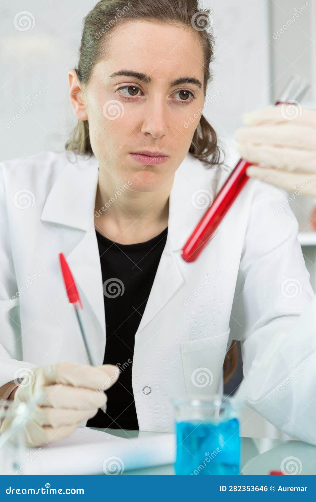 Laboratory Personnel Analyzing Red Liquid in Tube Stock Photo - Image ...