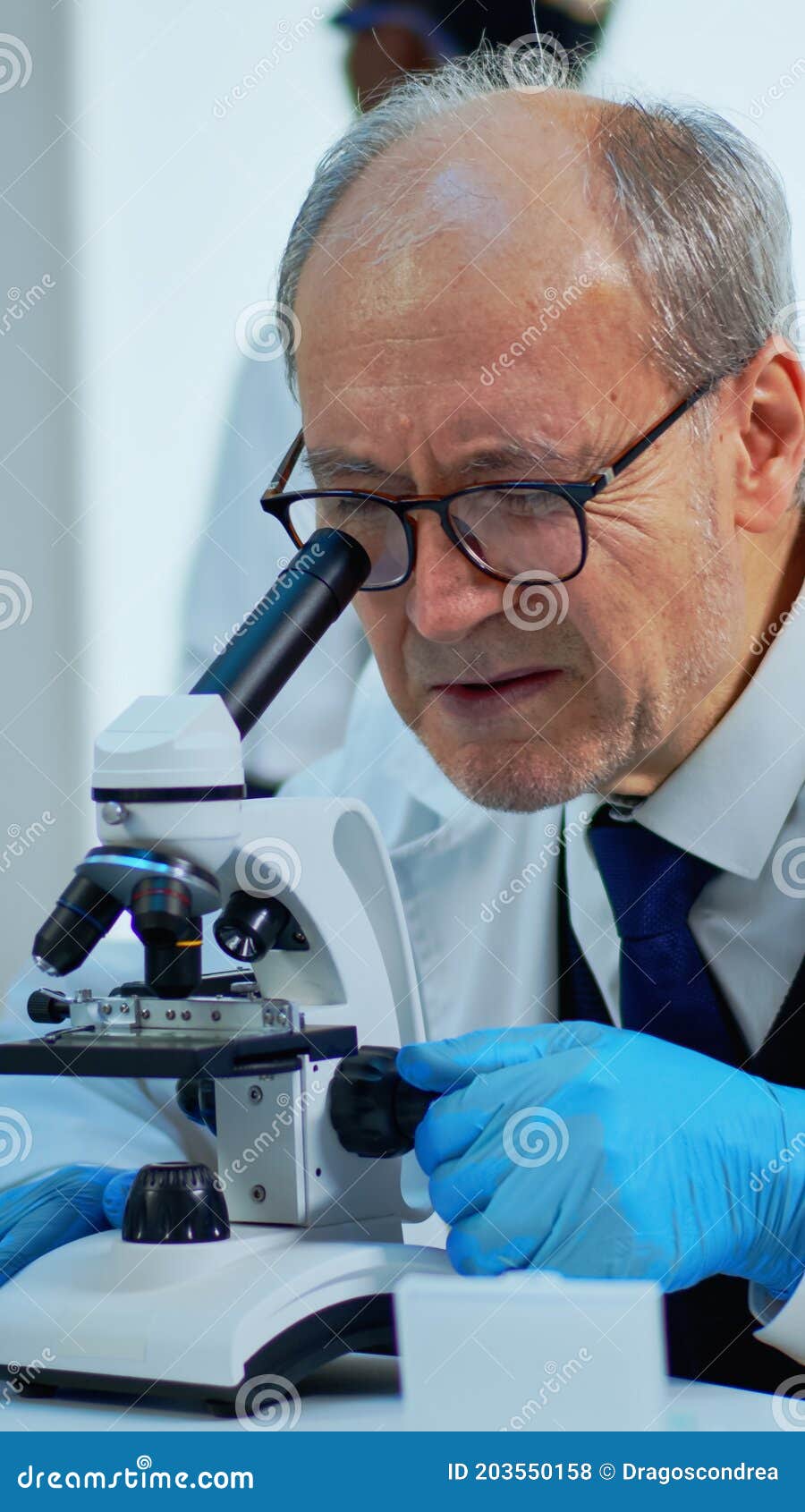 Laboratory Scientist Conducting Experiment Looking at Microscope in ...