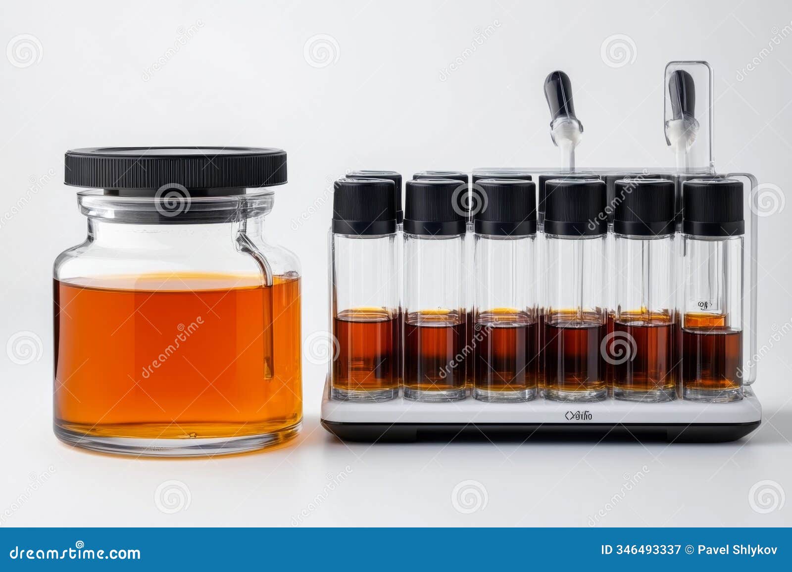 Laboratory Setup with Amber Liquid in a Jar and Test Tubes on a Clear ...