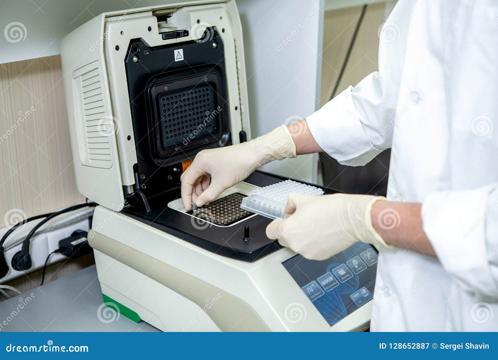 A Laboratory Specialist Places Test Tubes with Test Samples in a ...