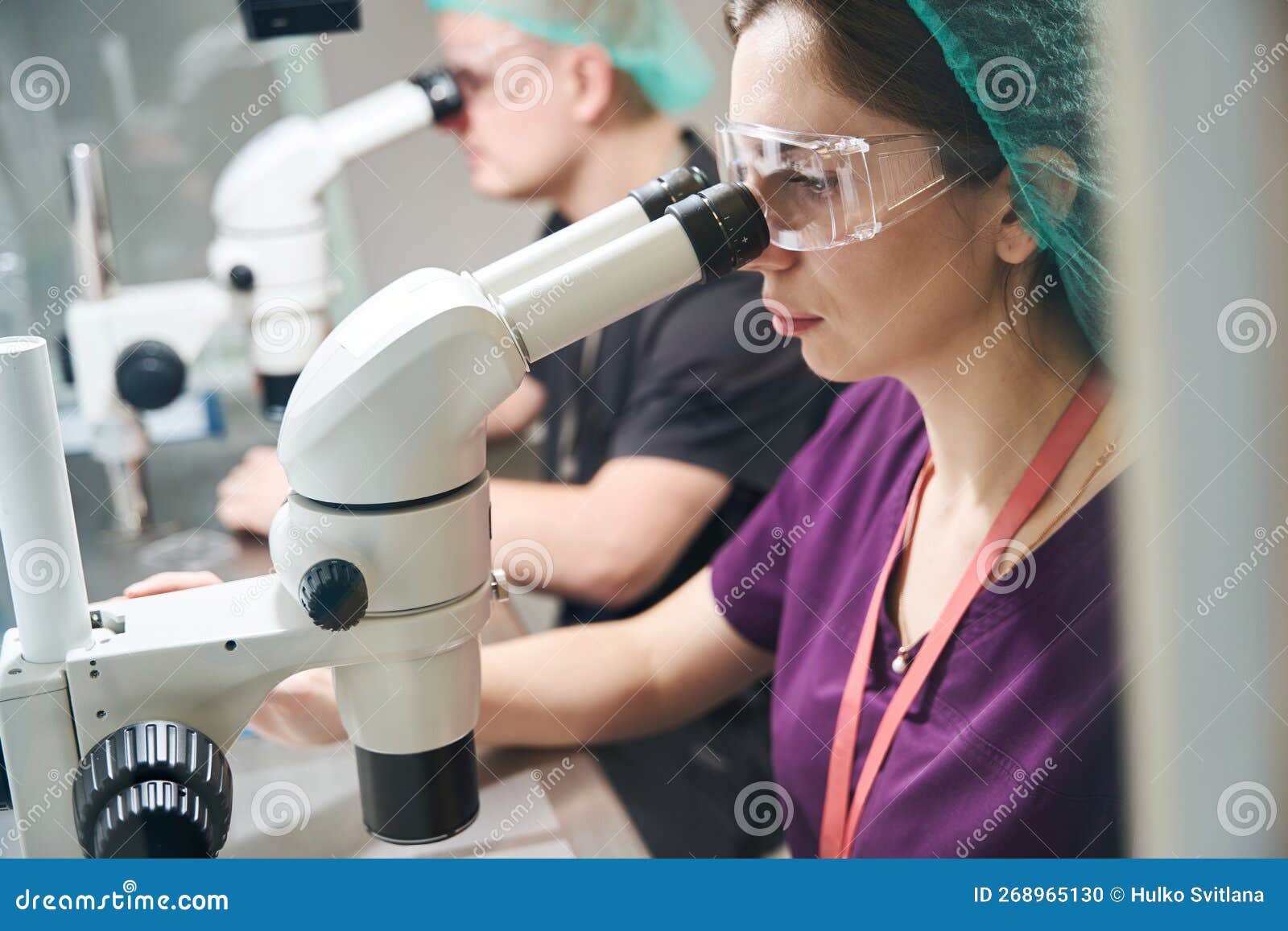 Laboratory Staff in Special Glasses Look through Microscopes Stock ...