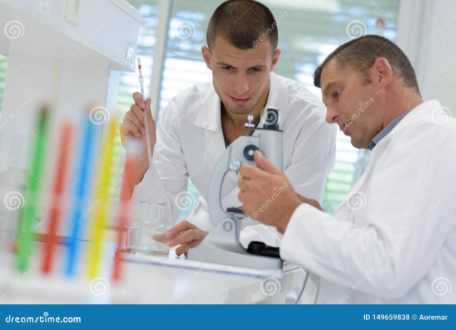 Laboratory Students and Teacher Supervising Stock Photo - Image of ...