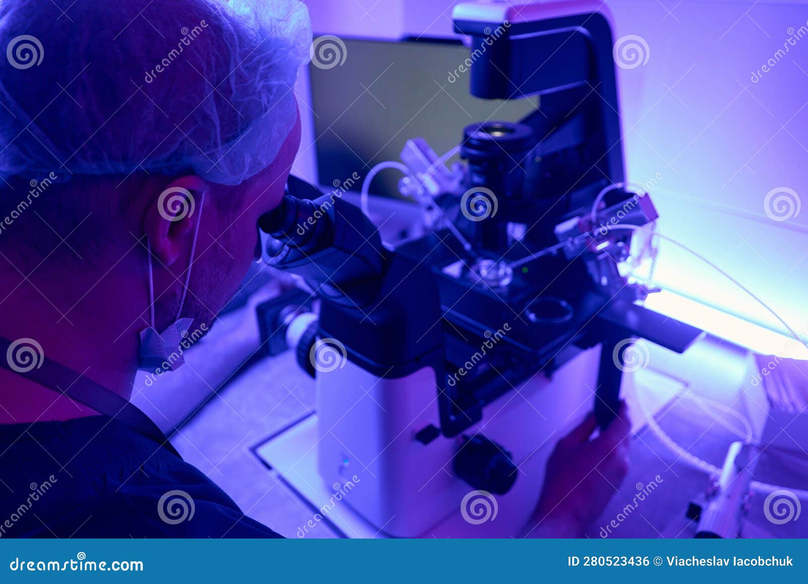 Laboratory Technician is Adjusting Microscope with Micromanipulator ...