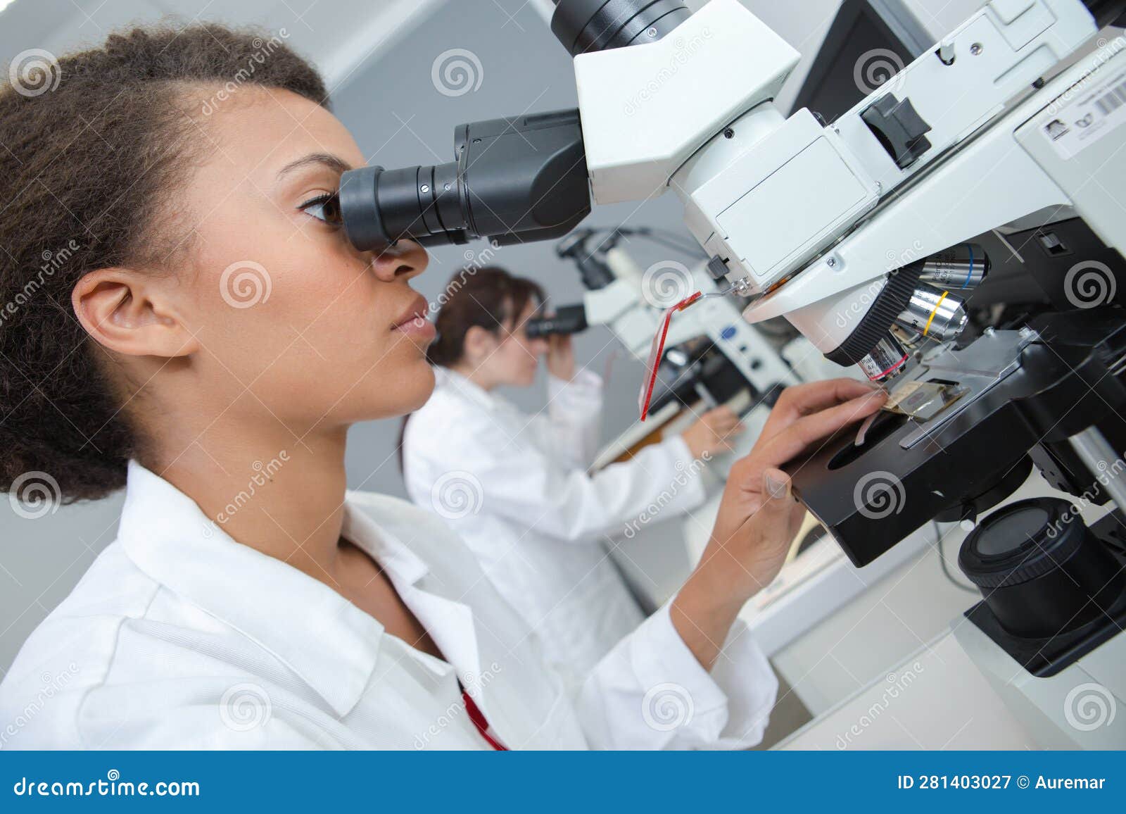 Laboratory Technician Looking into Microscope Eyepiece Stock Image ...