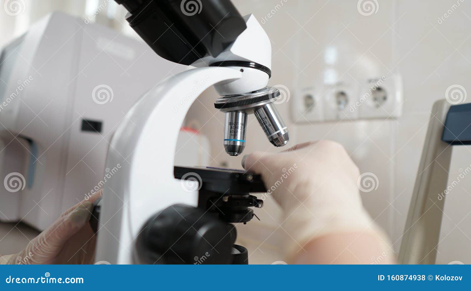 Laboratory Technician Makes Fine-tuning of the Microscope To Study the ...