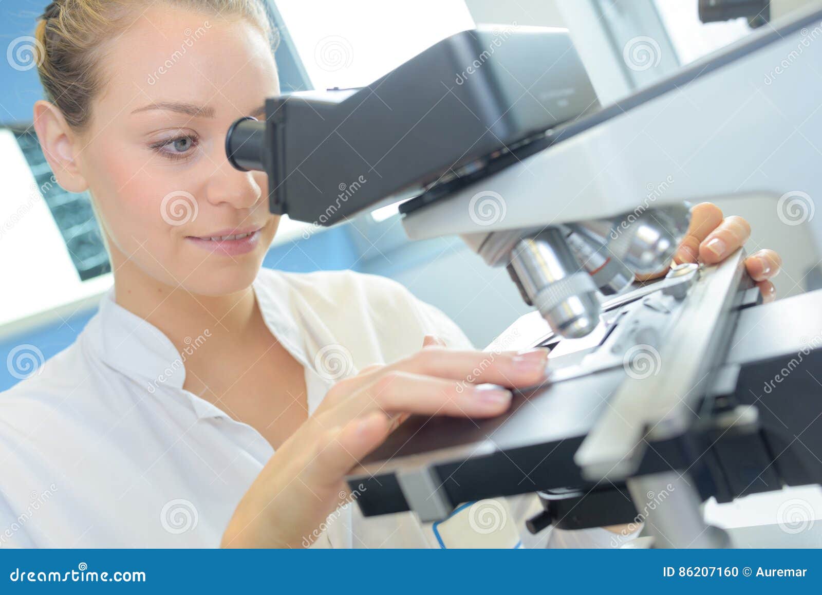 Laboratory Technician Observing through Microscope Stock Photo - Image ...