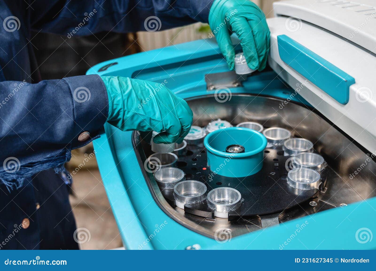 The Laboratory Technician Sets the Cups with Samples into Spectrometer ...