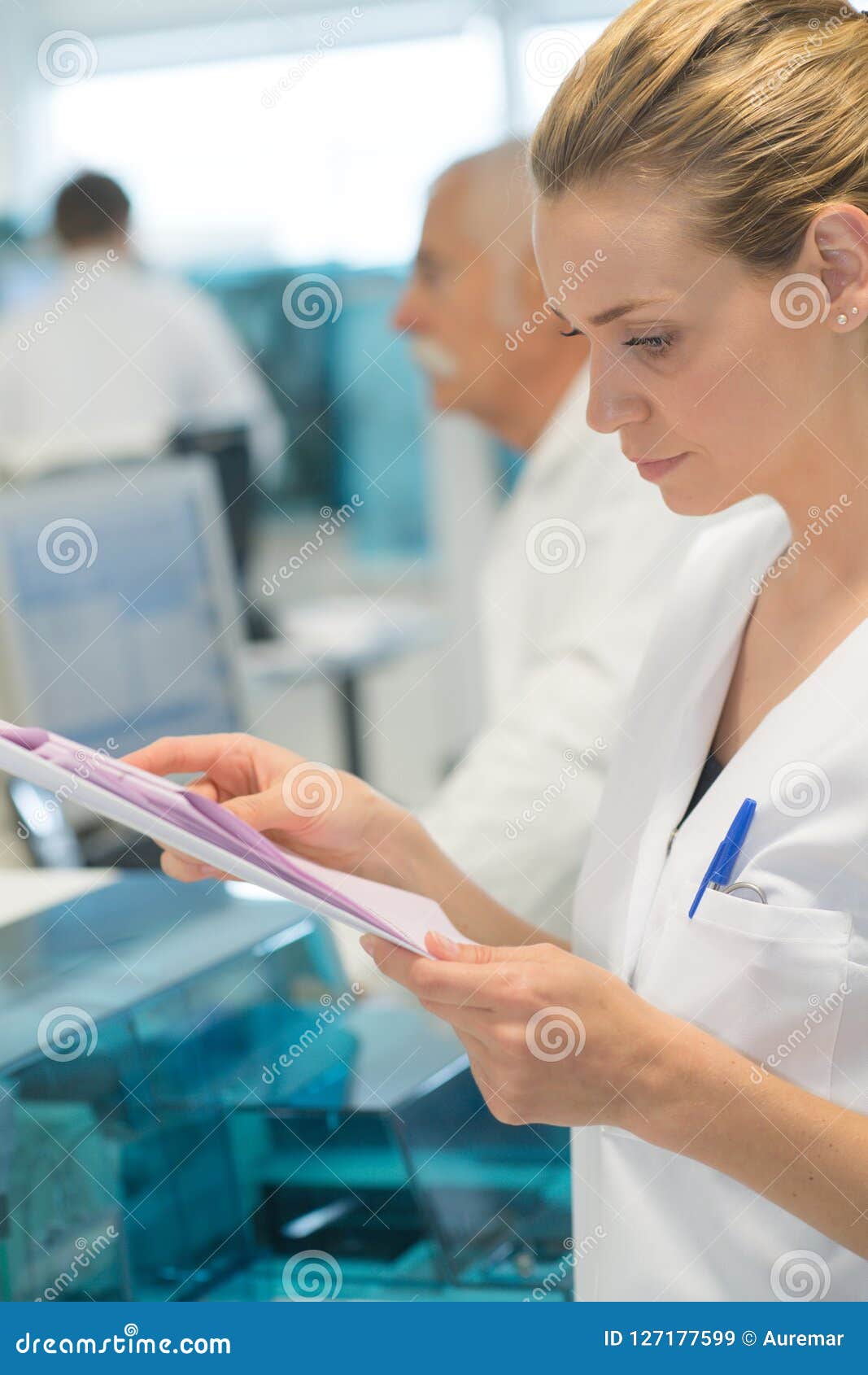 Laboratory Worker Looking at Paperwork Stock Image - Image of young ...