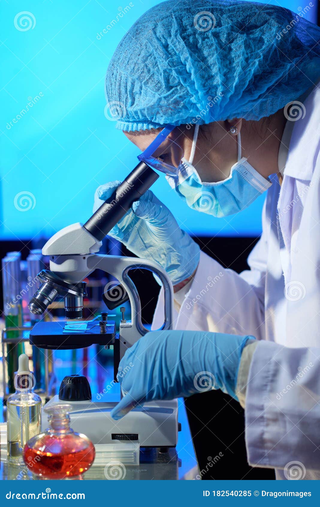Laboratory Worker Looking through Microscope Stock Image - Image of ...