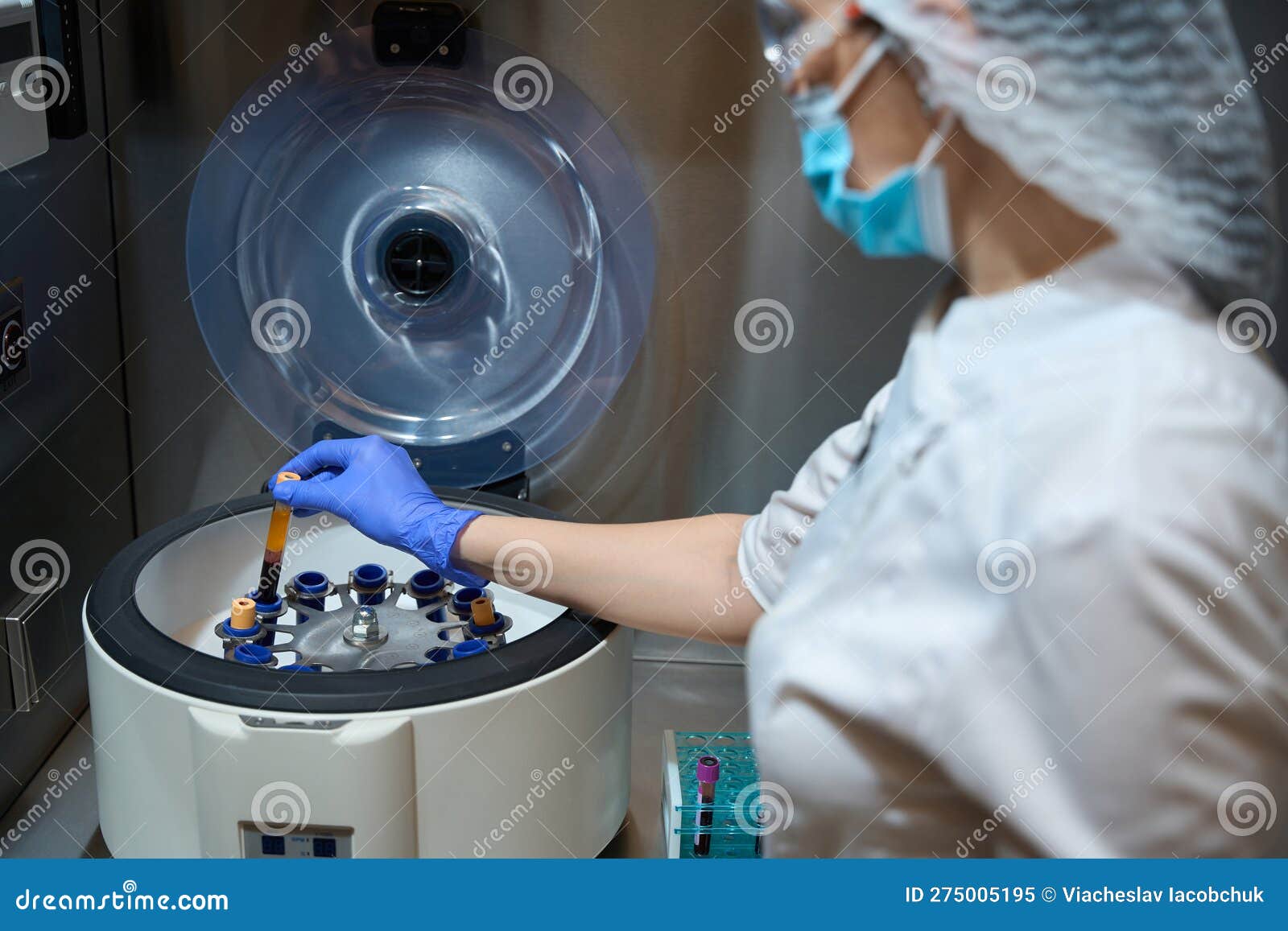 Laboratory Worker with a Test Tube with Blood in it and a Separator ...