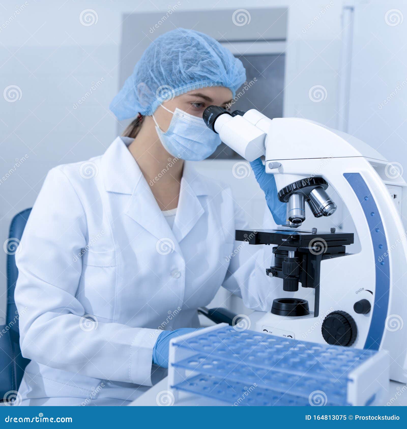 Laboratory Worker Using Modern Microscope in Mask and Gloves Stock ...