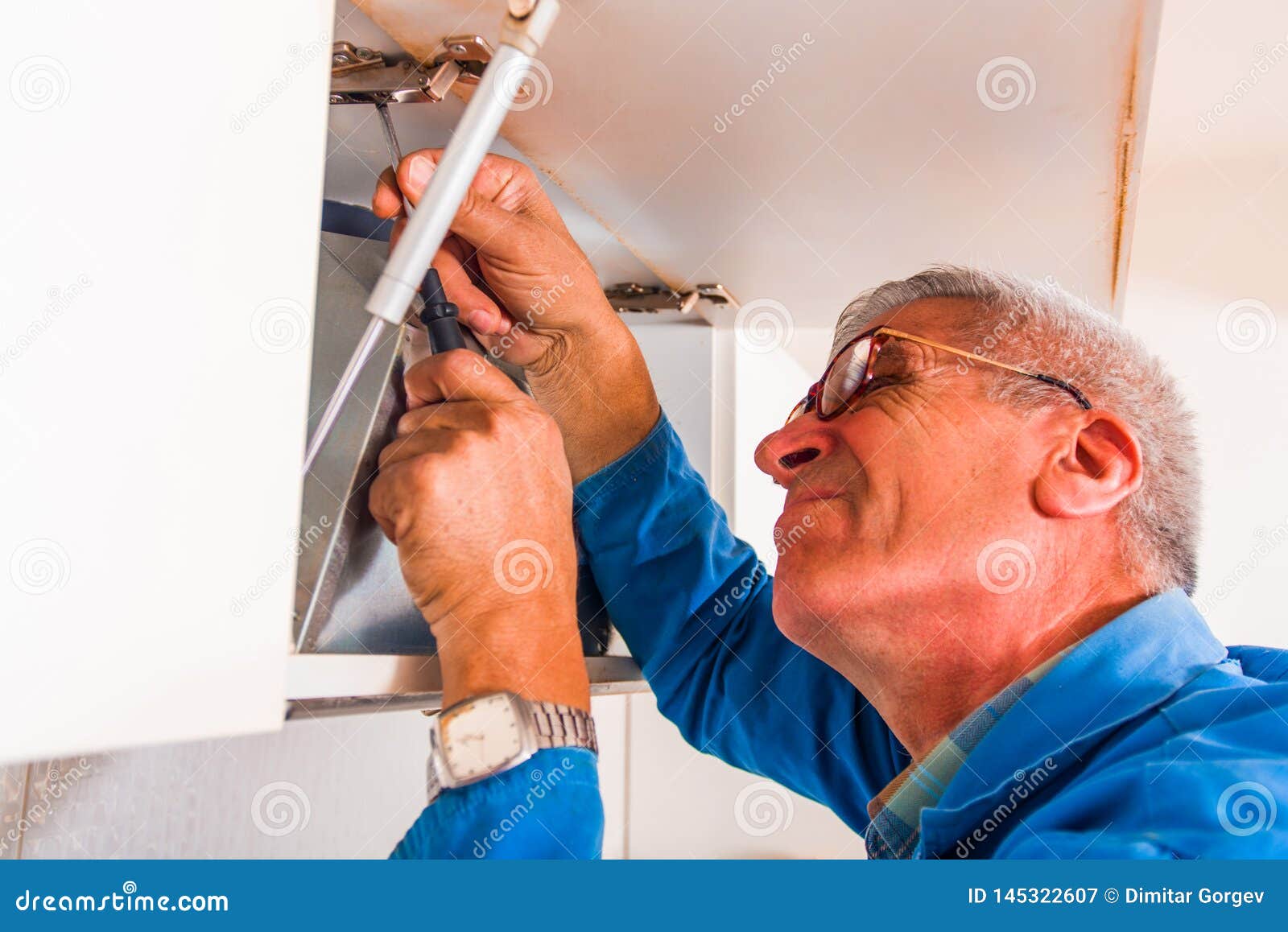 Laborer Fixing the Cupboard Stock Image - Image of installing, plumber ...