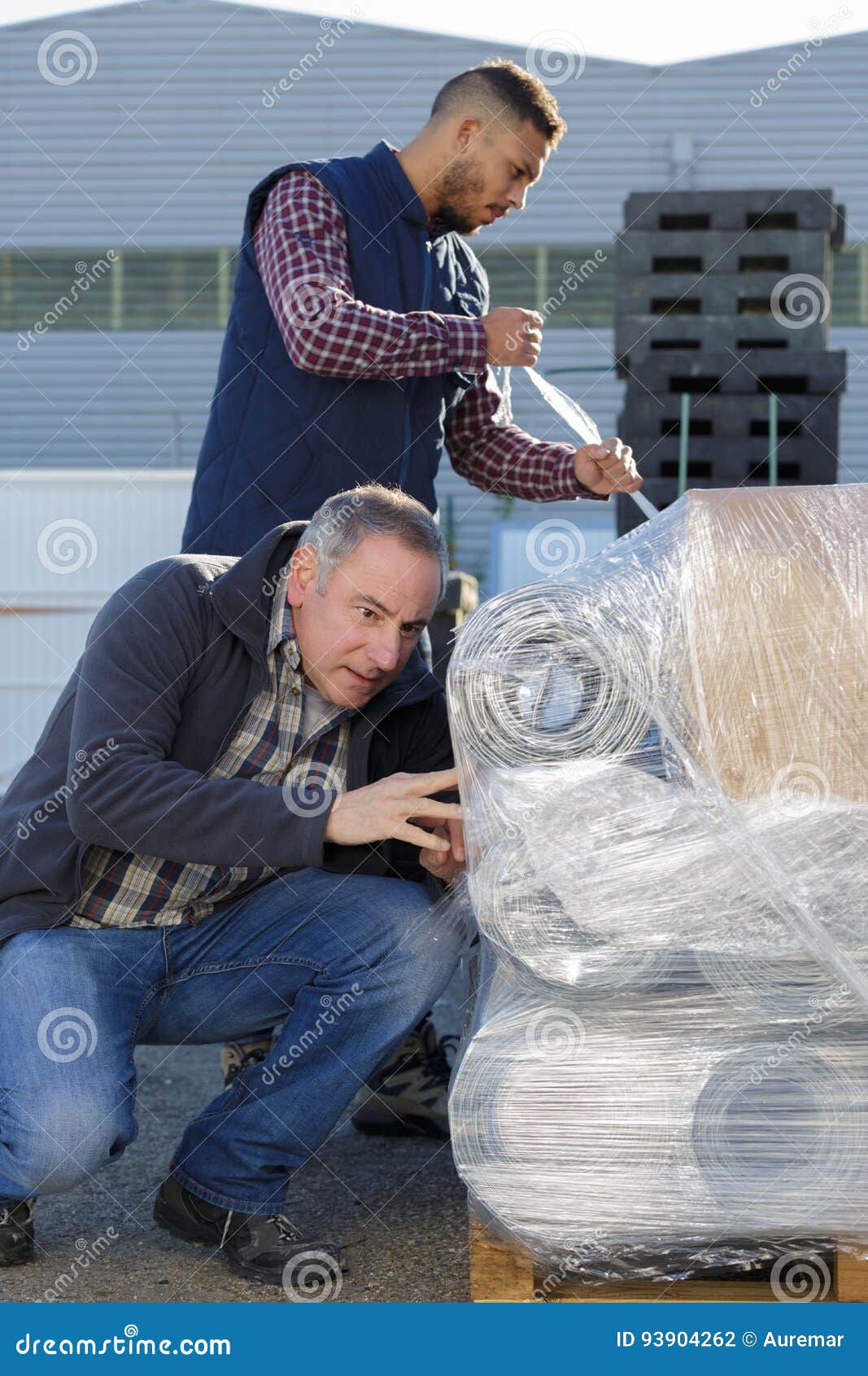 Laborers Outside Factory Unwrapping Shipping Stock Photo - Image of ...