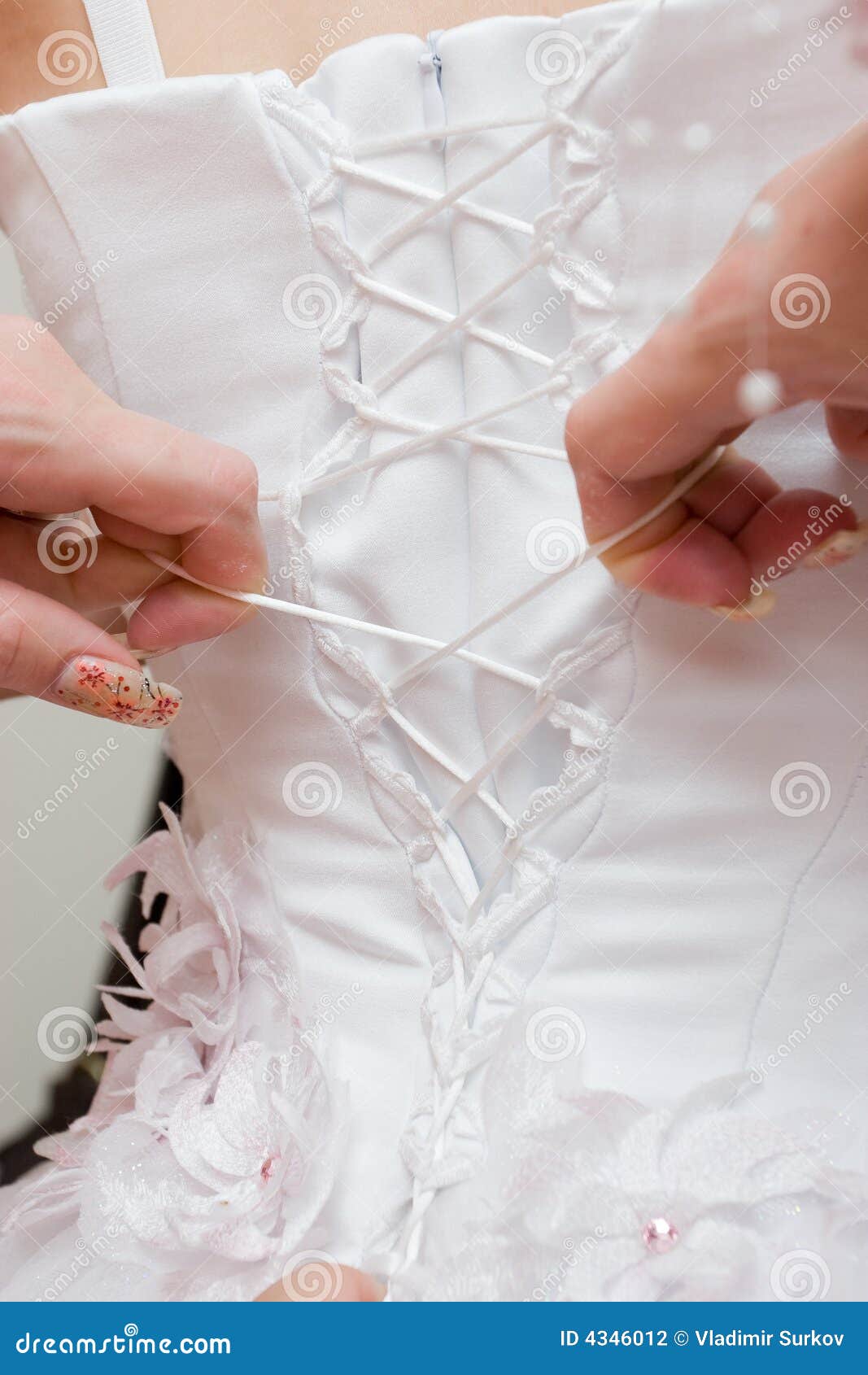 Lacing up a wedding dress stock photo. Image of bridal - 4346012