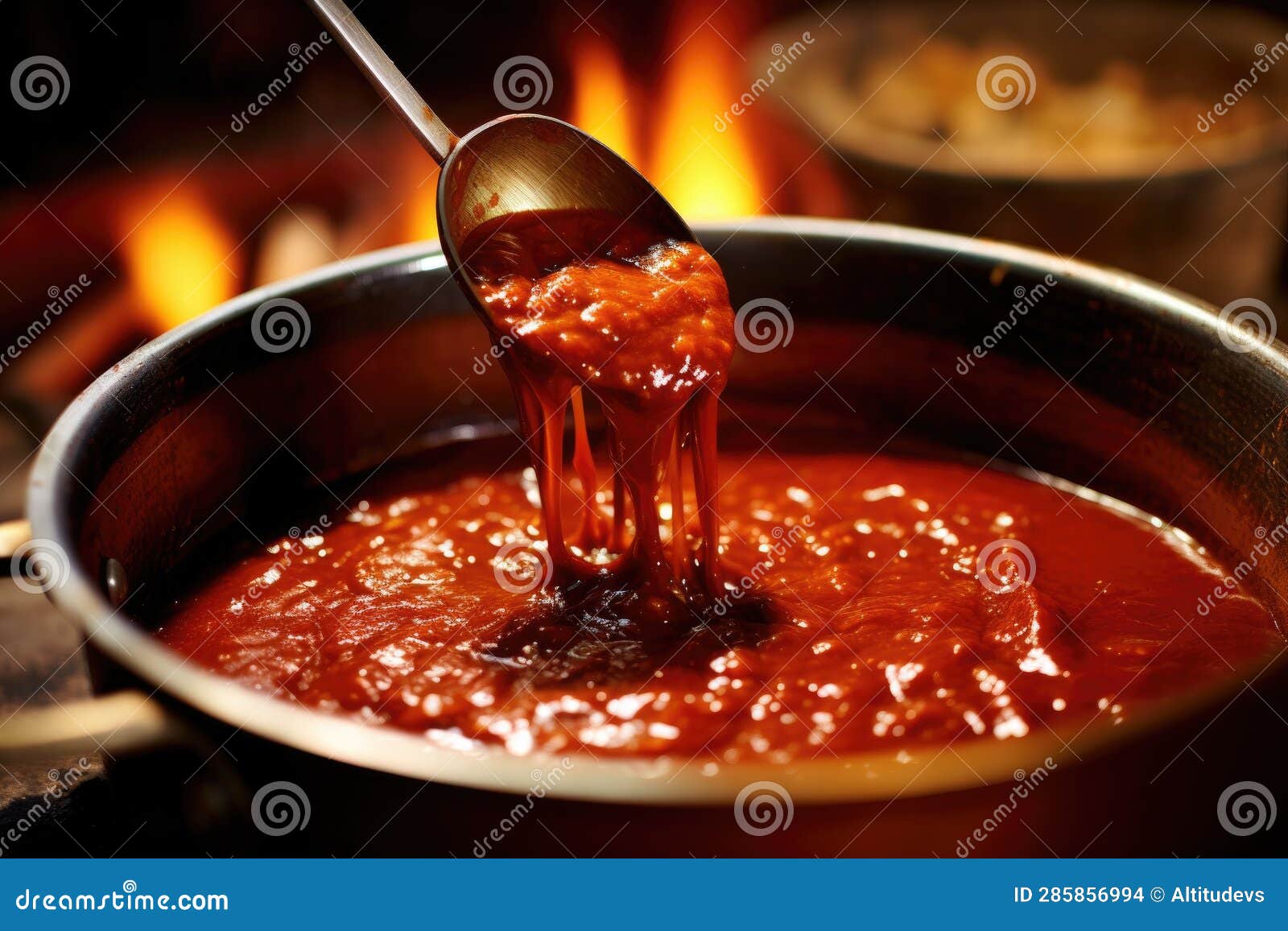A Ladle Scooping Up a Generous Serving of Pasta Sauce from a Pot Stock ...