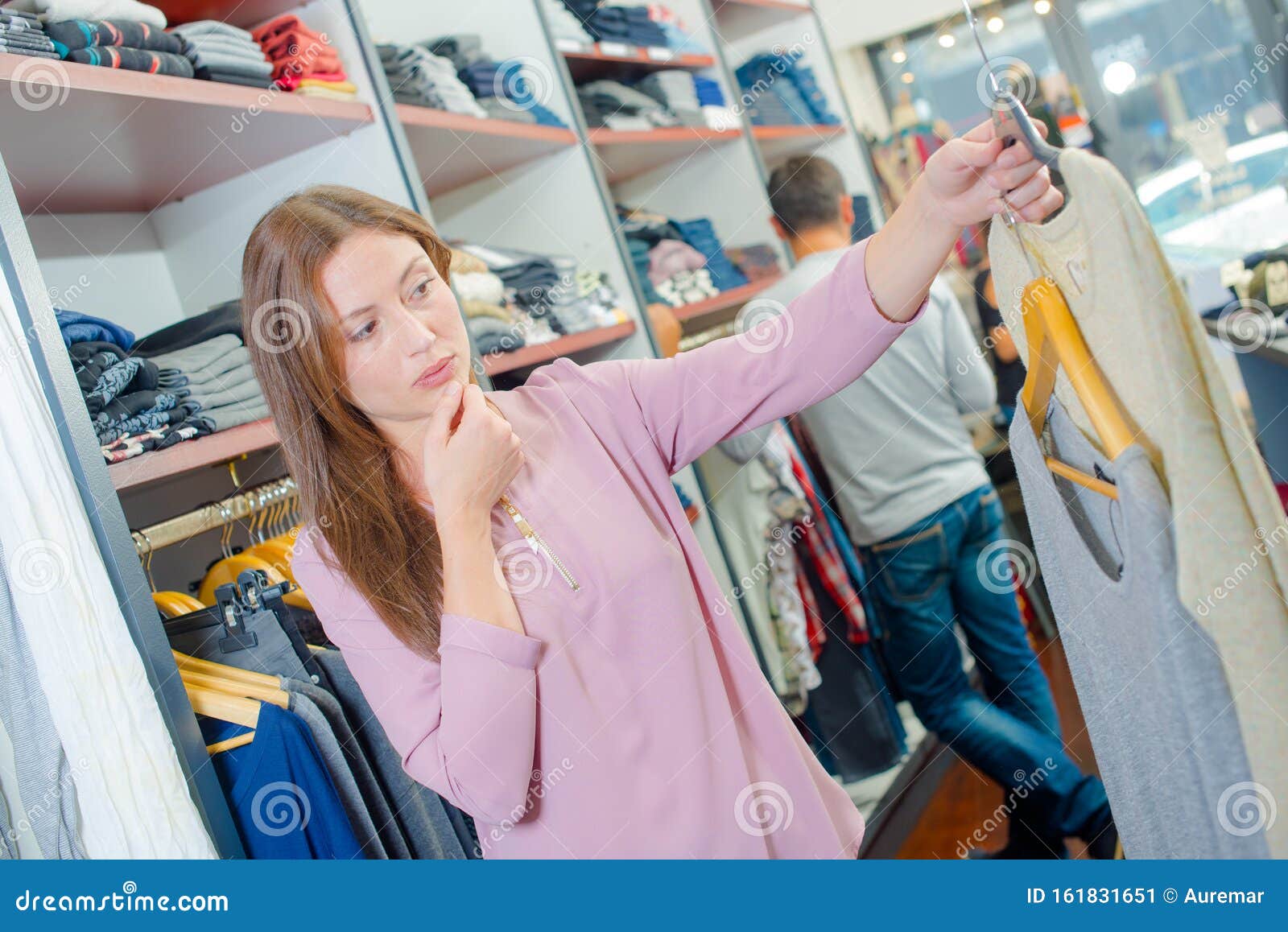 Lady comparing two jumpers stock image. Image of adult - 161831651
