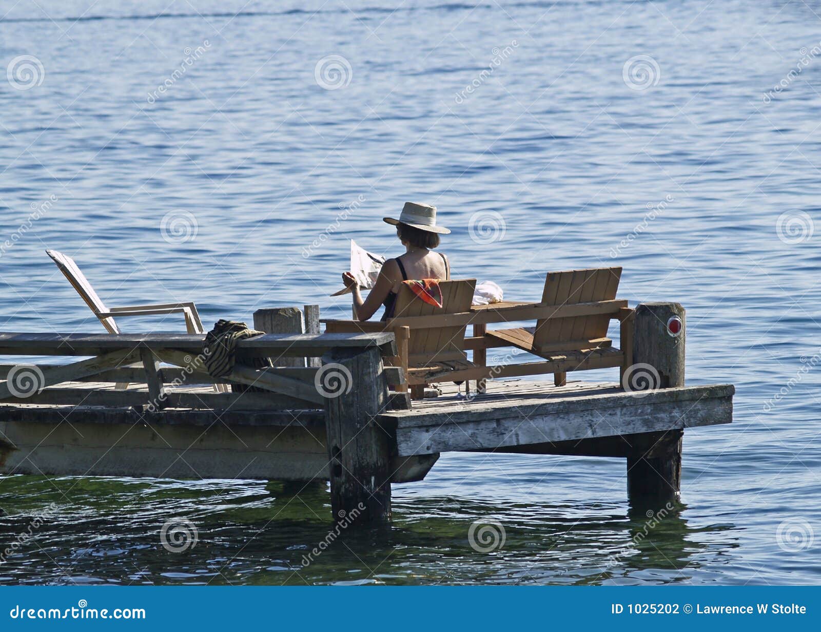Lady on Dock stock photo. Image of dock, pier, chair, lake - 1025202