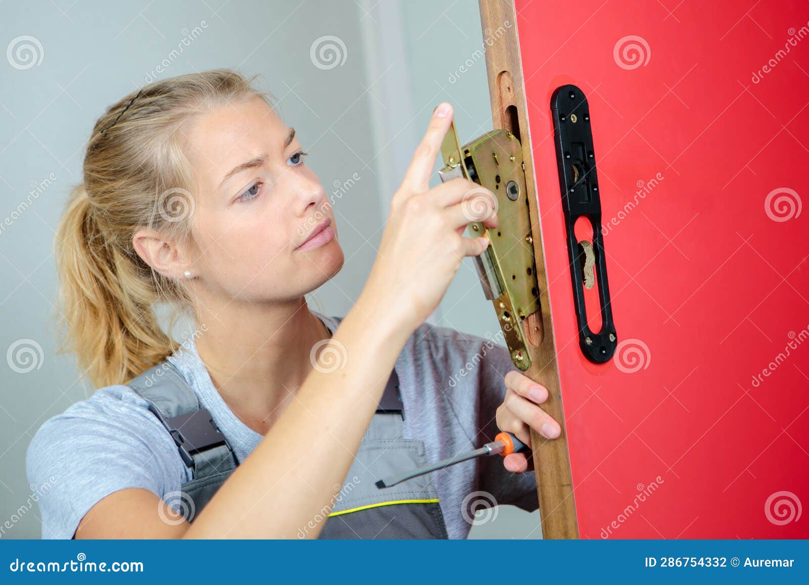 Lady fitting lock in door stock photo. Image of entry - 286754332