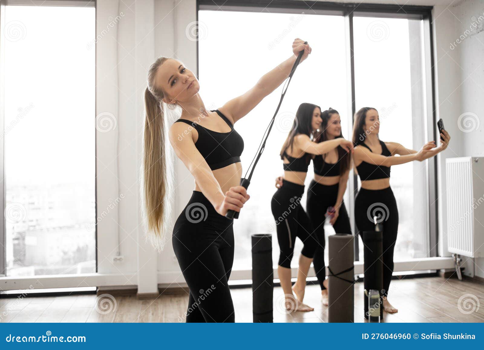 Lady Holding Skipping Rope while Others Taking Selfies Stock Photo ...