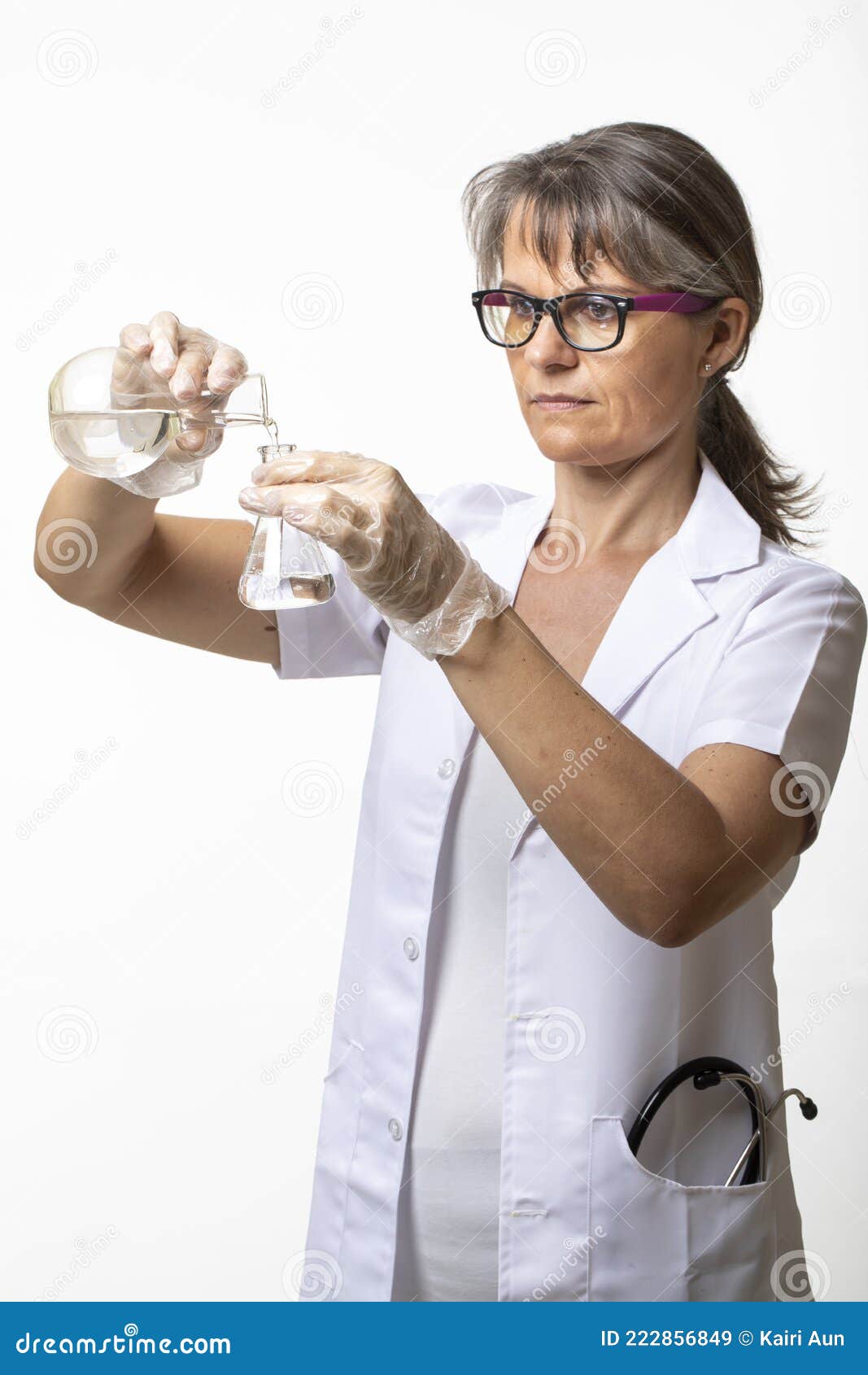 Lady in a Lab Coat Pouring Liquid into a Lab Flask Stock Image - Image ...