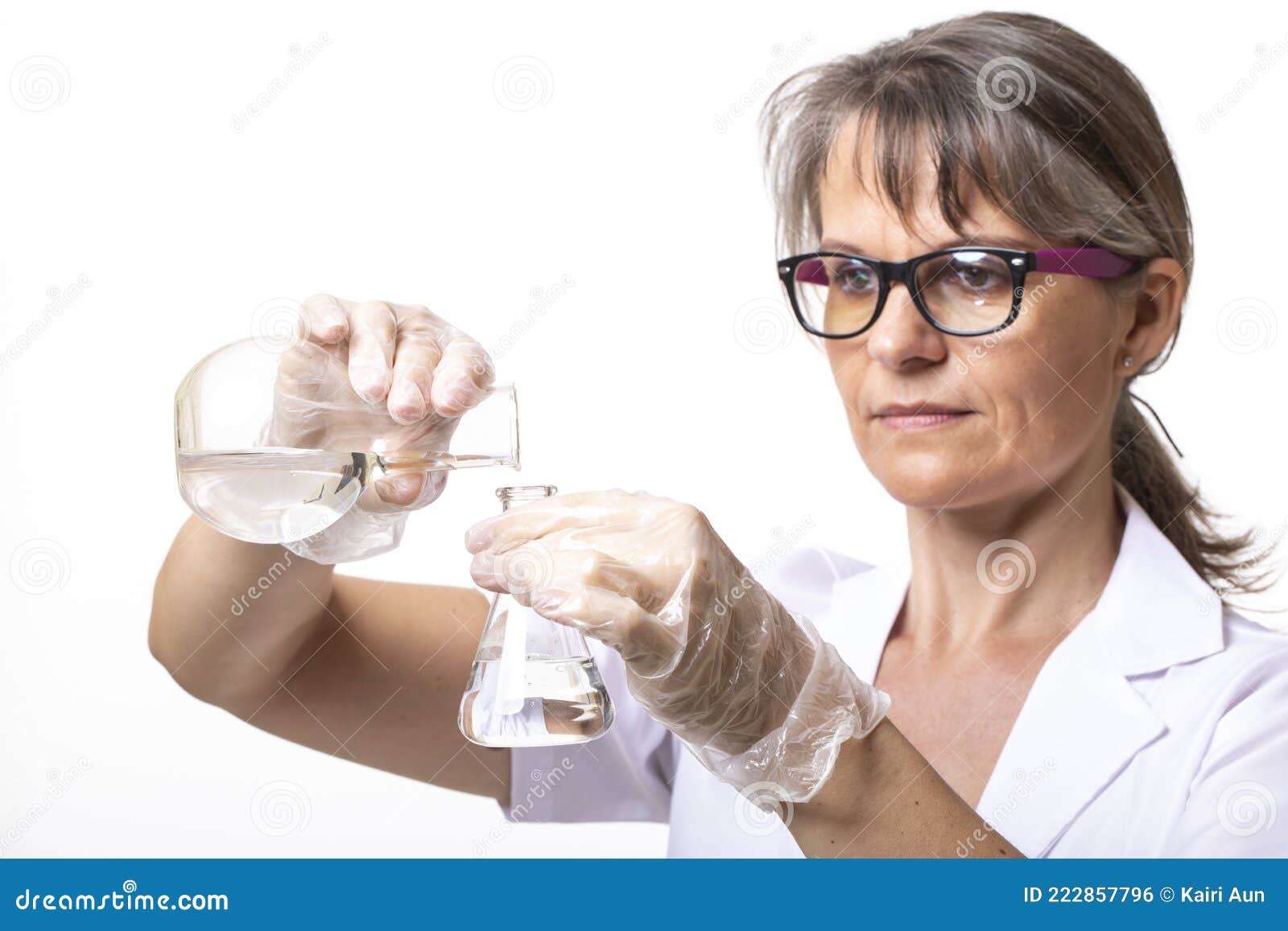 Lady in a Lab Coat Pouring Liquid into a Lab Flask Stock Photo - Image ...