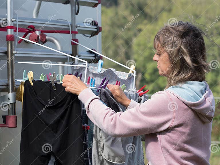 A Lady Motorhome Owner Hangs Washing At The Rear Of Her Recreational Vehicle On Her Bike Rack